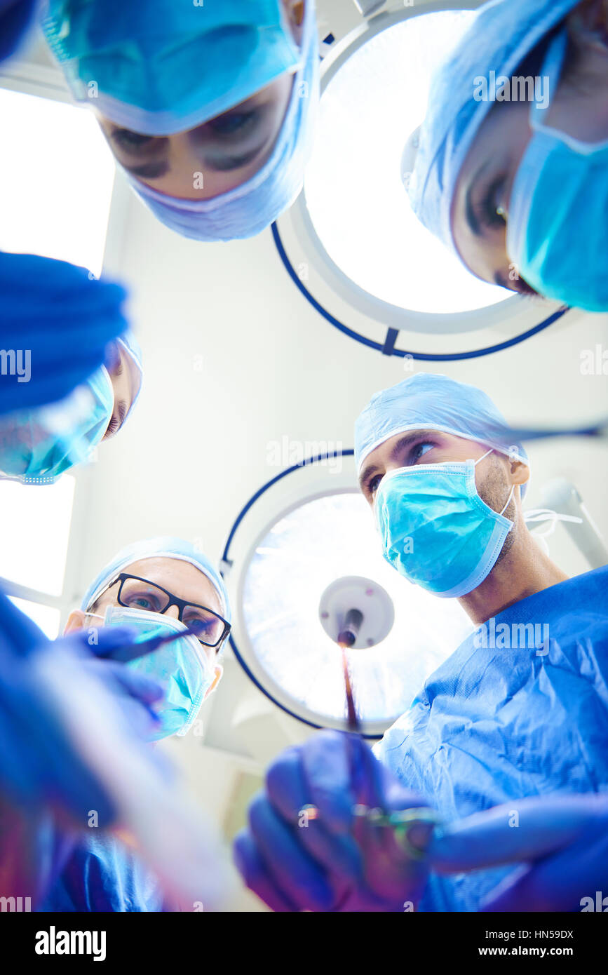 Team of surgeons over the operating table Stock Photo - Alamy