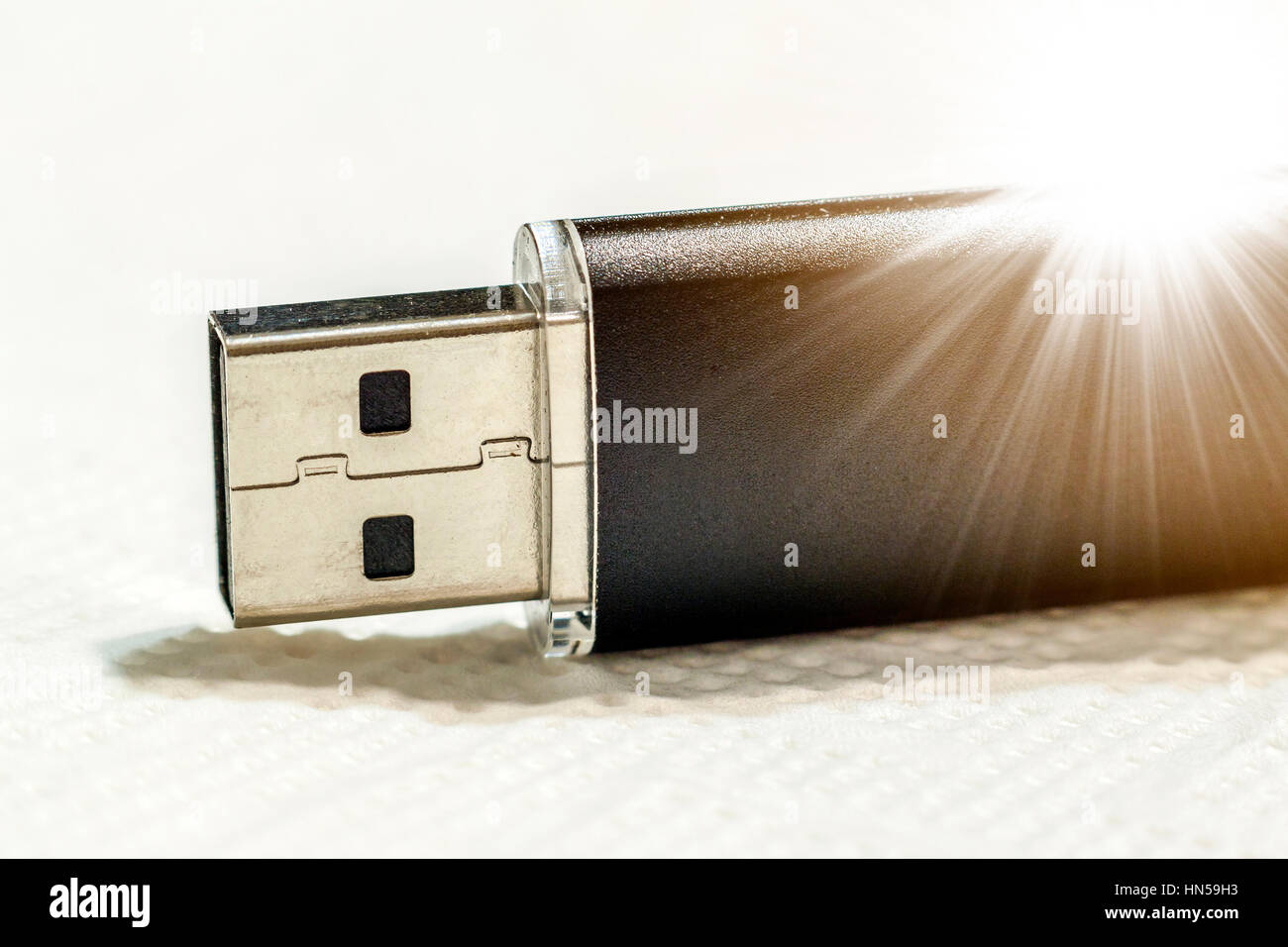 Black usb flash drive isolated on white background with sun beams soft ...