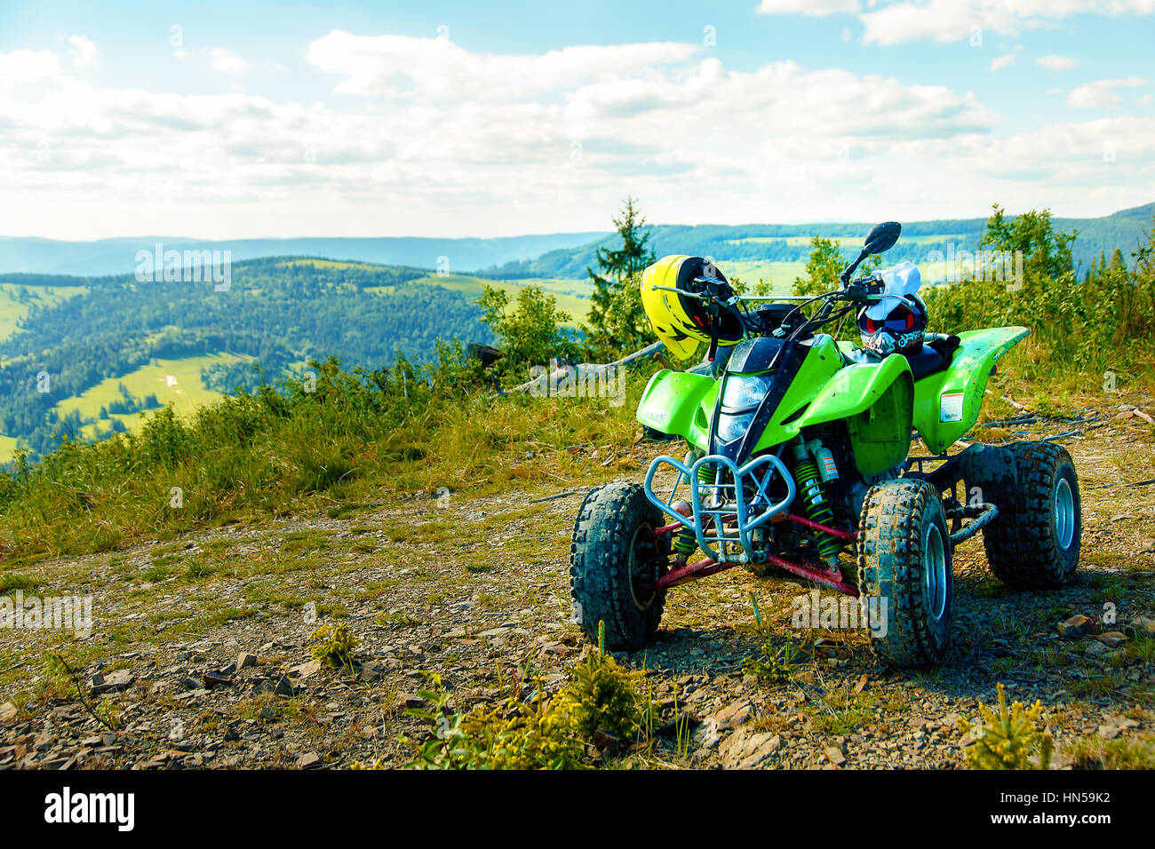 Green Quad in landscape on mountain road Stock Photo - Alamy