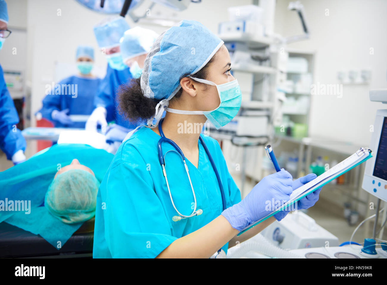 Woman writing down the records on form Stock Photo - Alamy