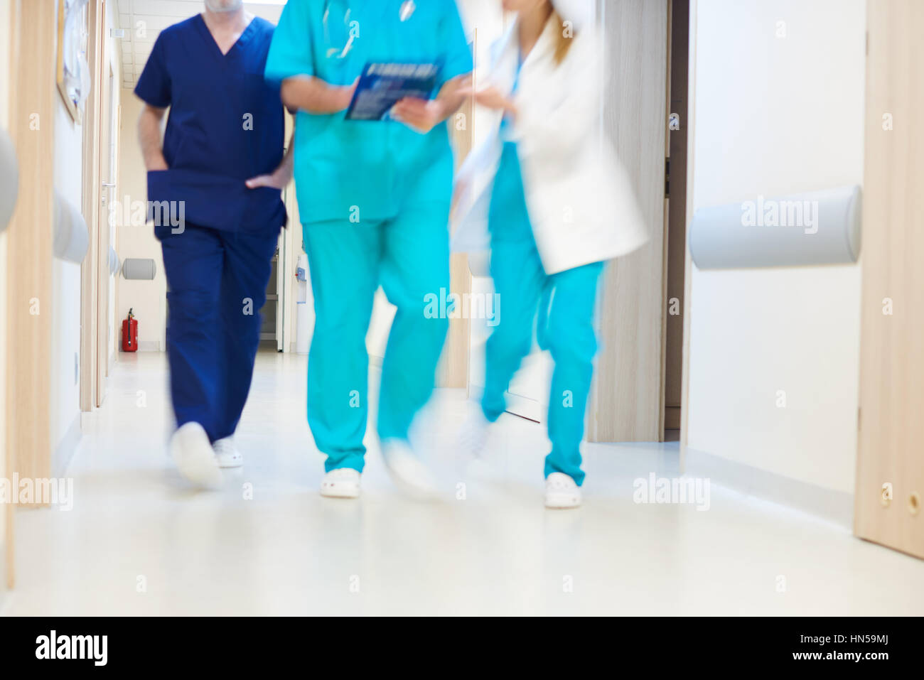 Doctors walking through corridor in hospital Stock Photo - Alamy