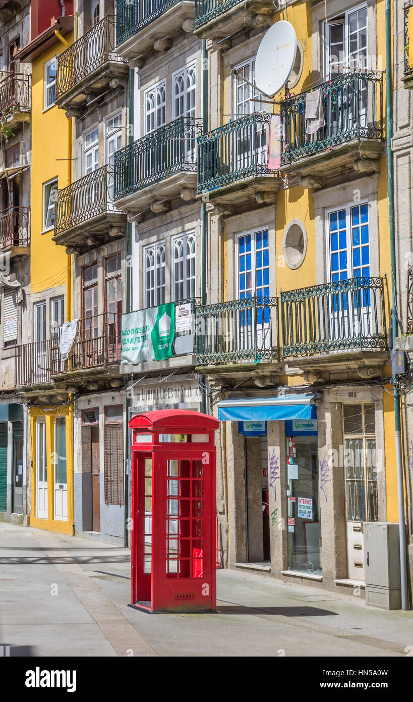 Classic red phone booth and colorful houses in Porto, Portugal Stock ...
