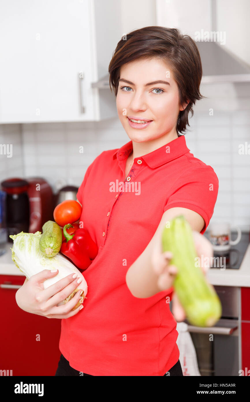 Girl with vegetables in hands Stock Photo - Alamy