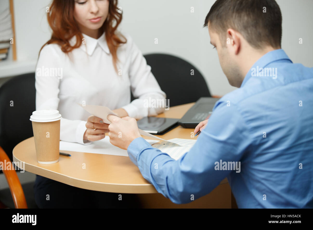 Office staff sitting at table Stock Photo - Alamy