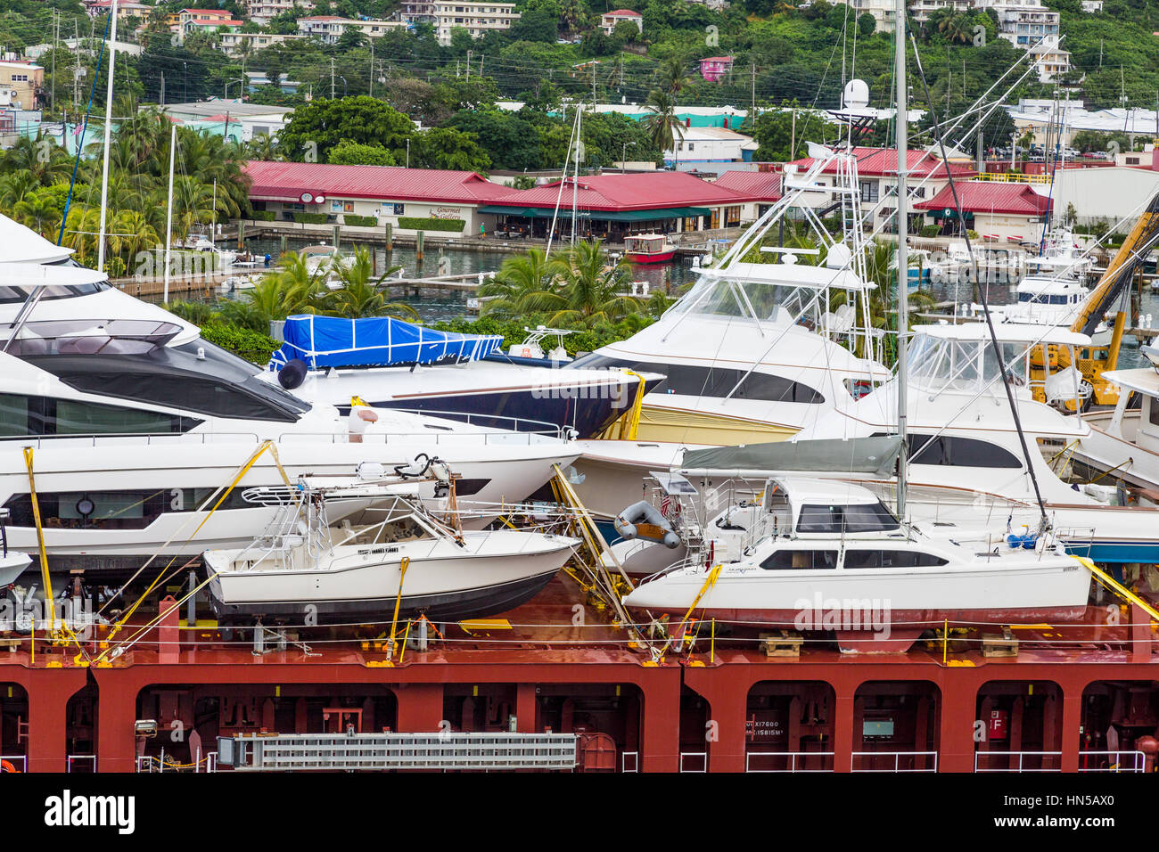 A ship delivering luxury yachts to a tropical harbor Stock Photo - Alamy