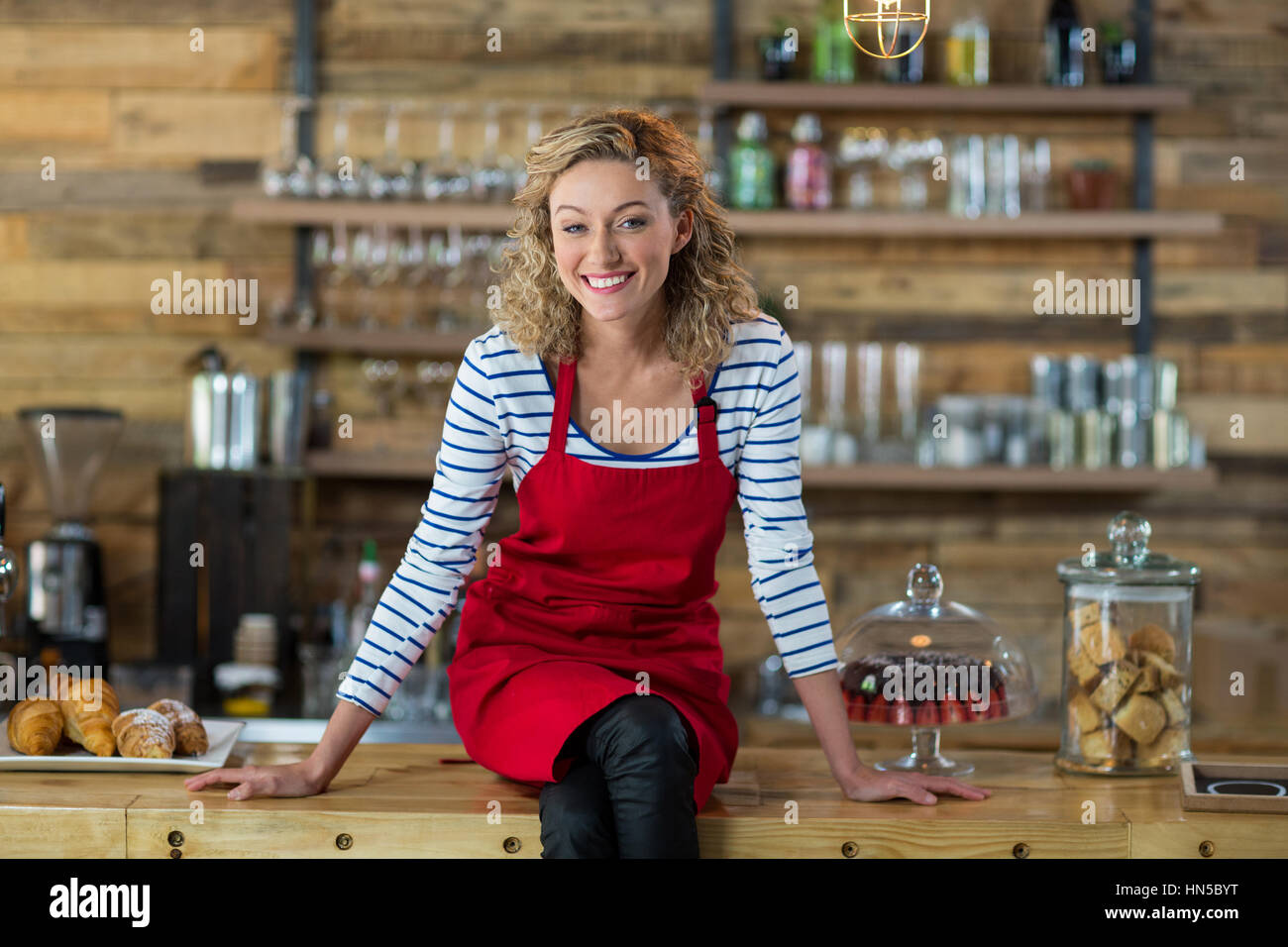 Portrait of waitress sitting at counter in cafÃƒÂ© Stock Photo - Alamy