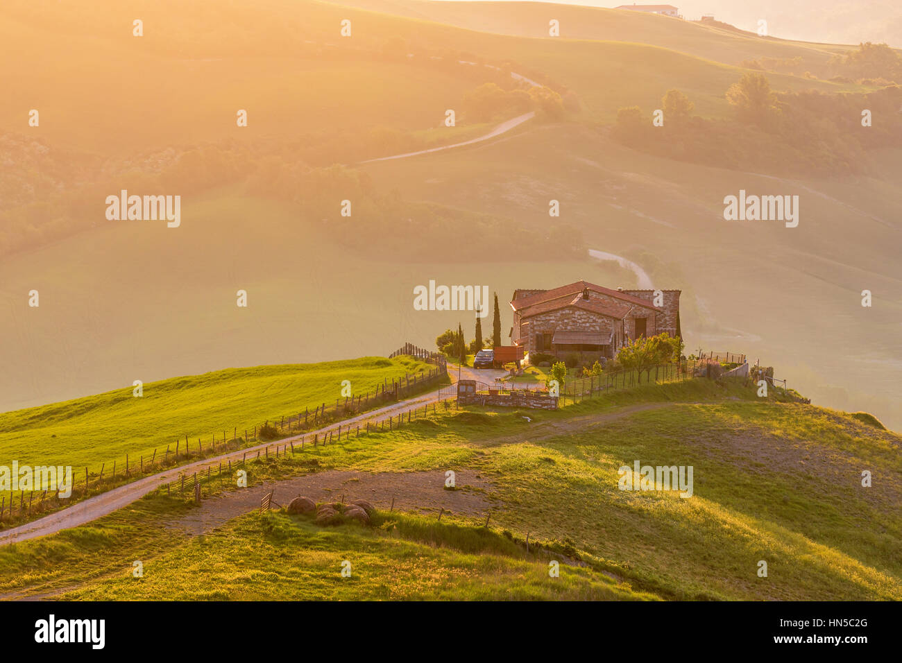 House on a hill in the dawn light with mist Stock Photo - Alamy