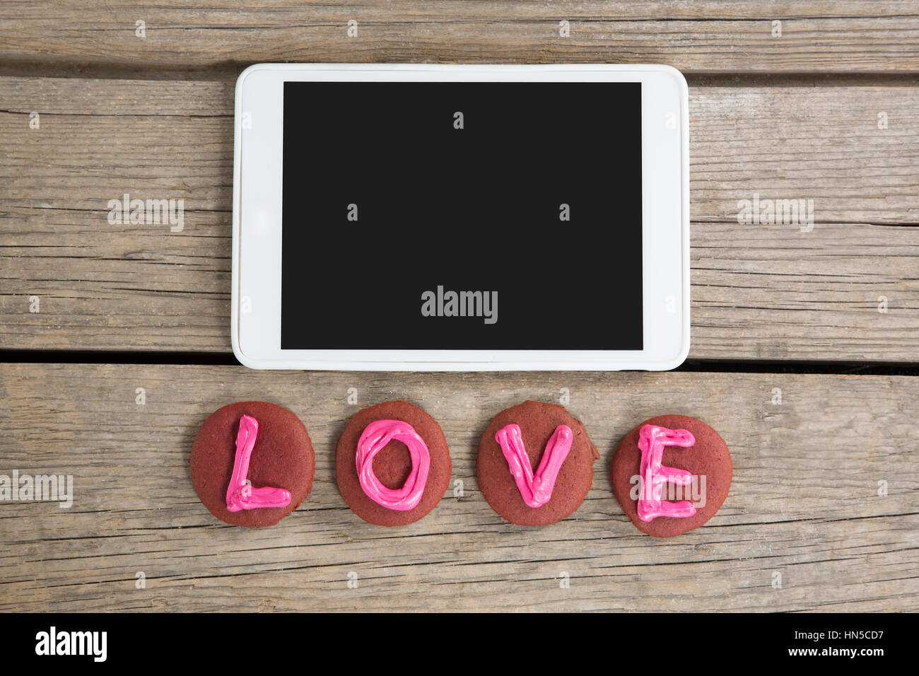 Conceptual image of digital tablet with cookies displaying love message ...
