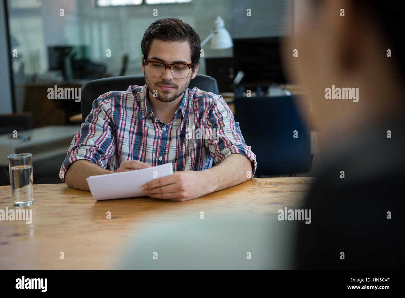 Business executive conducting job interview with woman in office Stock ...