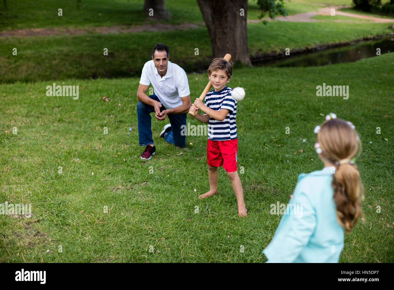 Happy family playing baseball in the park Stock Photo - Alamy