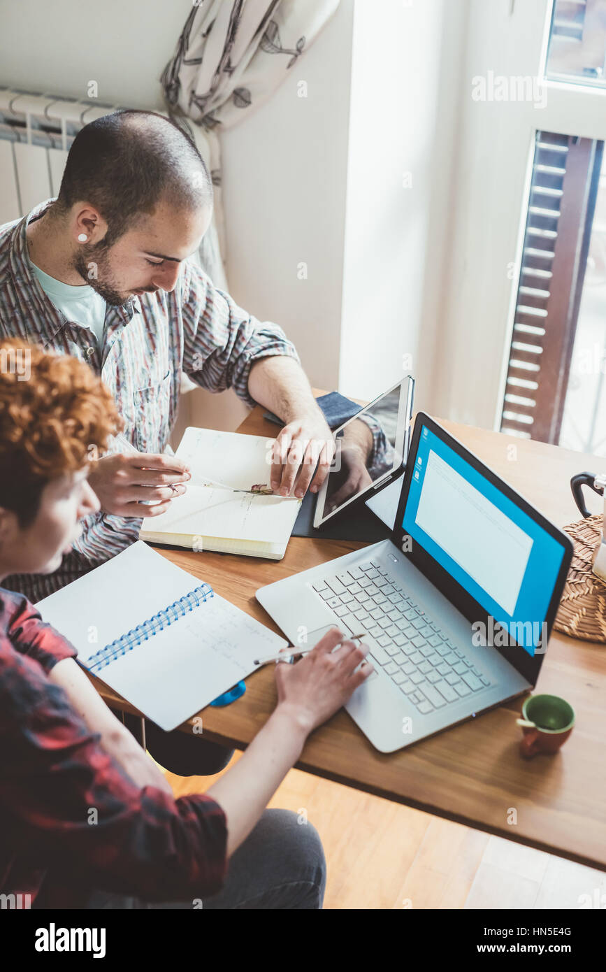 Team communication. Top view of two people discussing something using ...
