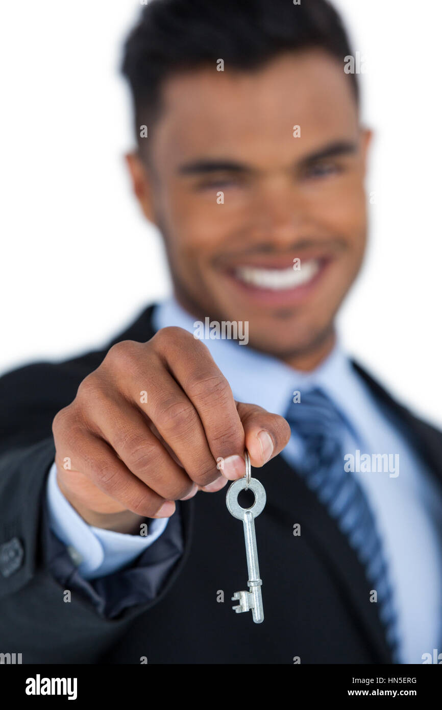 Businessman showing new house key on white background Stock Photo - Alamy