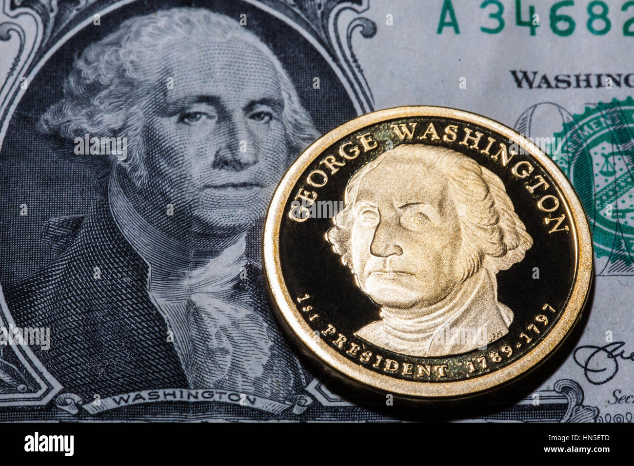 One dollar coin - George Washington - on one dollar banknote. Closeup ...