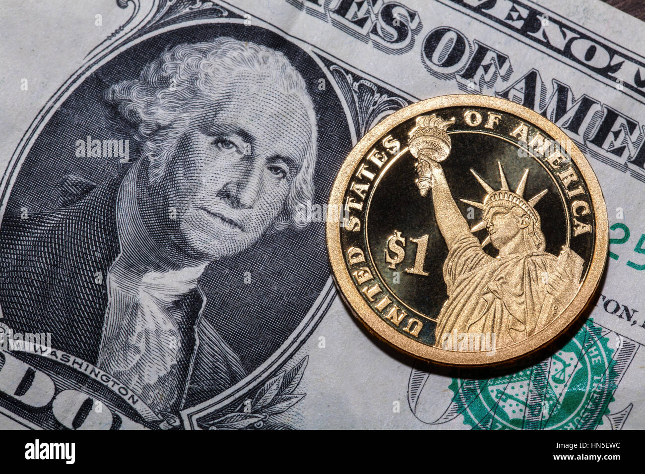 One dollar coin - The Statue of Liberty - on one dollar banknote ...