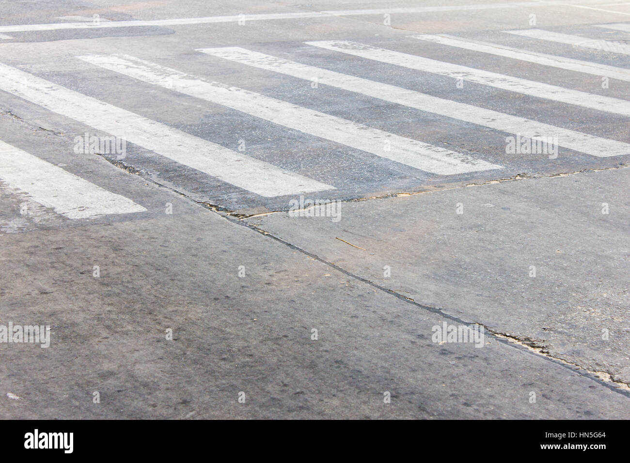 crosswalk on the bad dirty asphalt road Stock Photo - Alamy