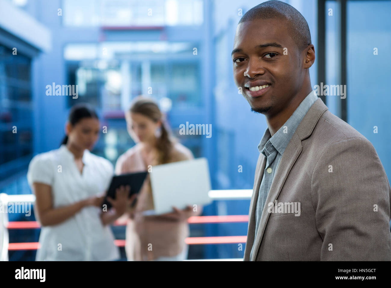 Portrait of business executive smiling in office Stock Photo - Alamy