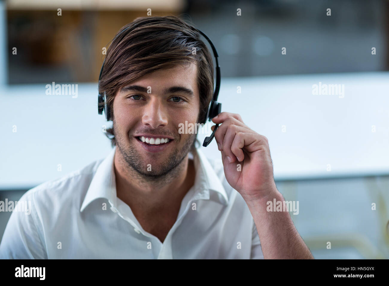 Portrait of smiling business executive with headsets in office Stock ...