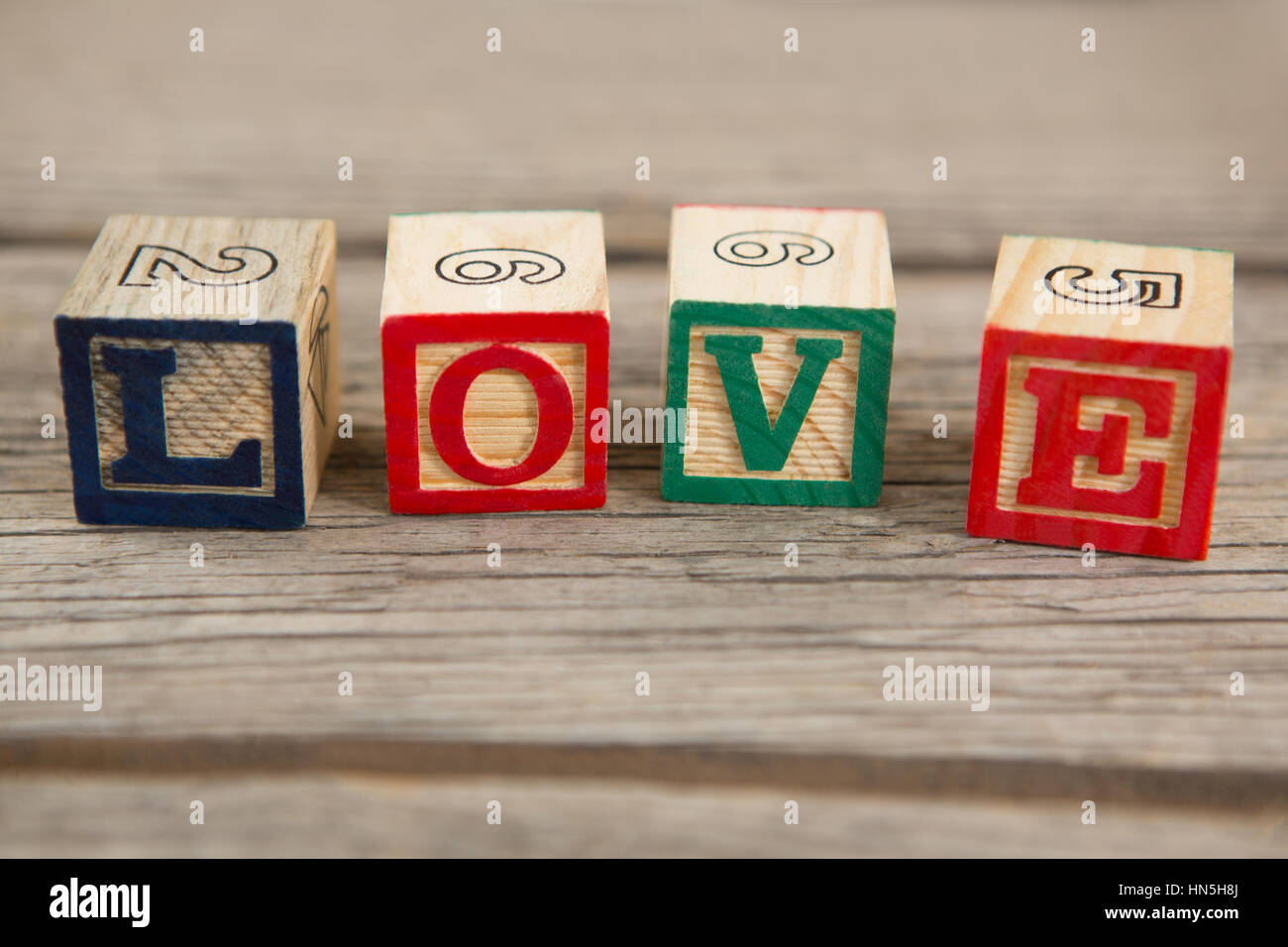 Blocks displaying love message on wooden surface Stock Photo - Alamy