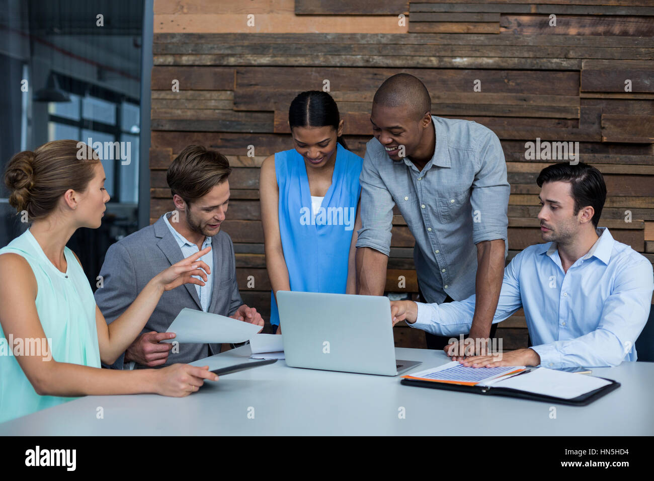 Business executives discussing during meeting in office Stock Photo - Alamy
