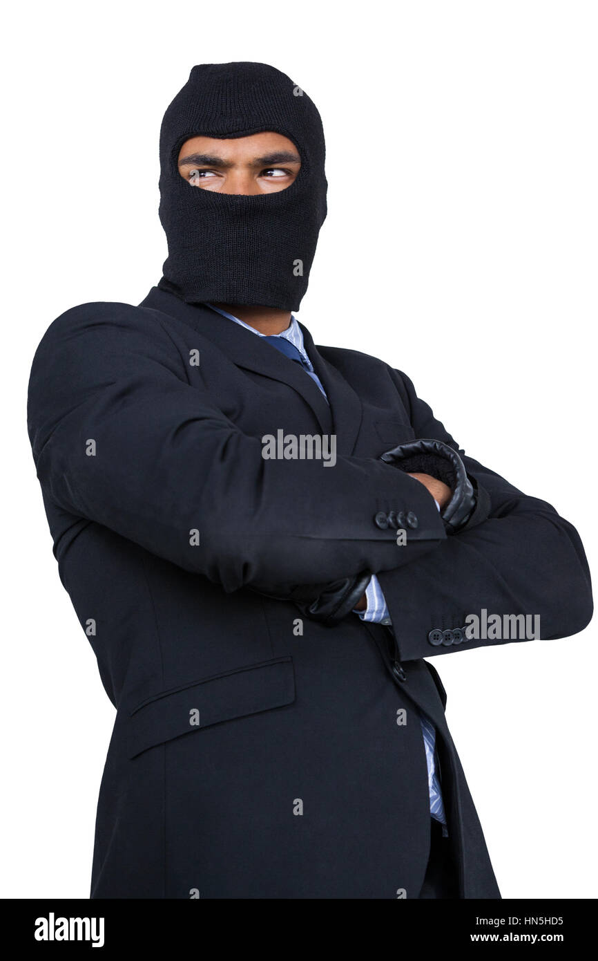 Hacker standing with arms crossed against white background Stock Photo ...