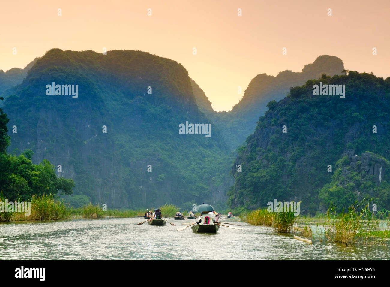 Tourist boats on the river in karst country in Tam Coc, Ninh Binh ...