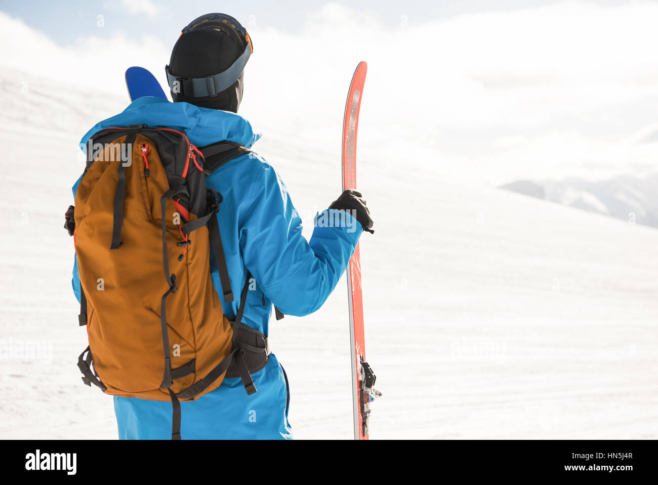 Rear view of skier looking at beautiful snow-covered mountains Stock ...