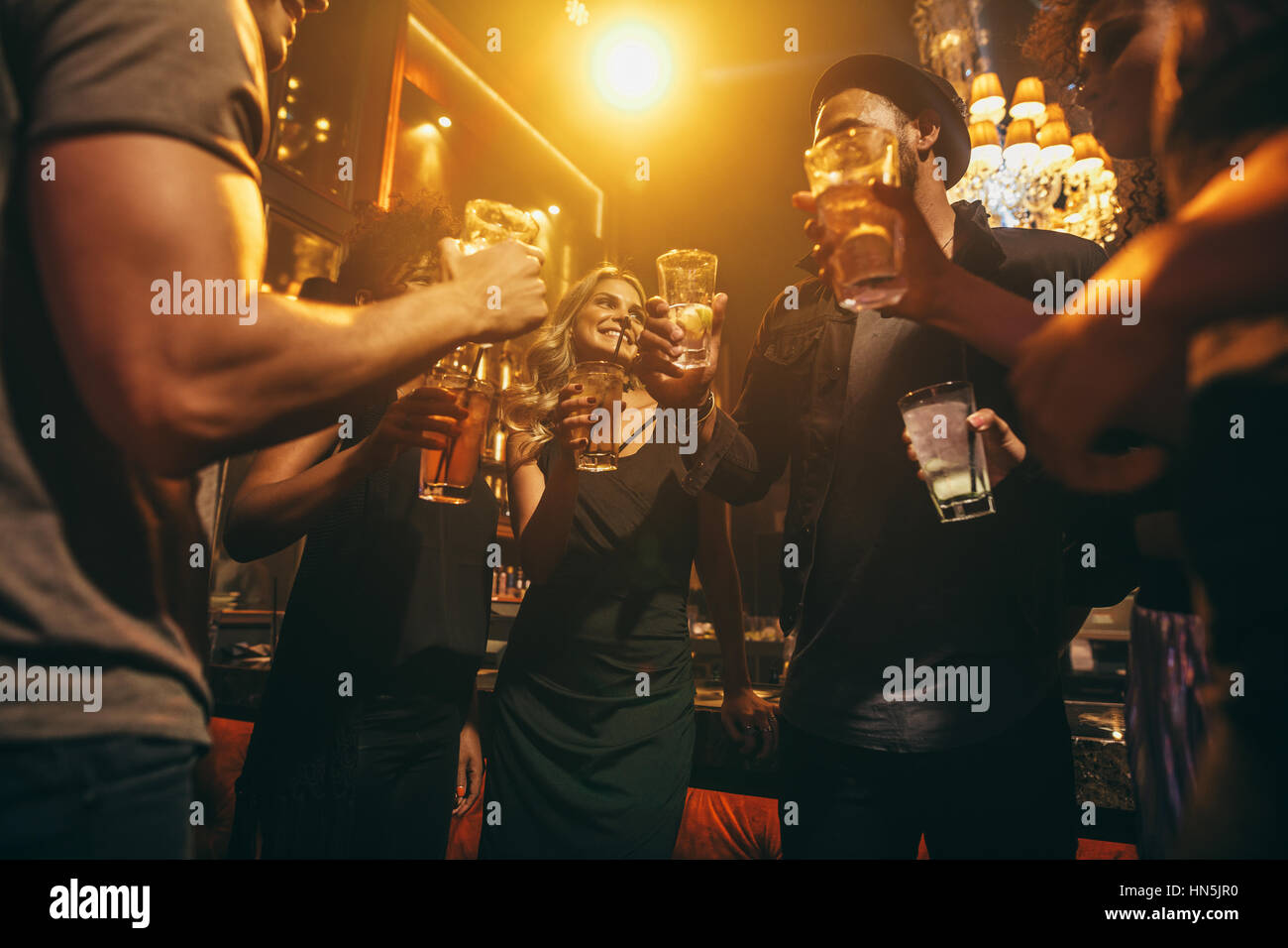 Group of friends having drinks at bar together. Young people at ...