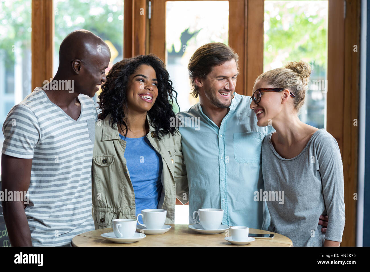 Happy group of friends interacting in cafÃƒÂ© Stock Photo - Alamy