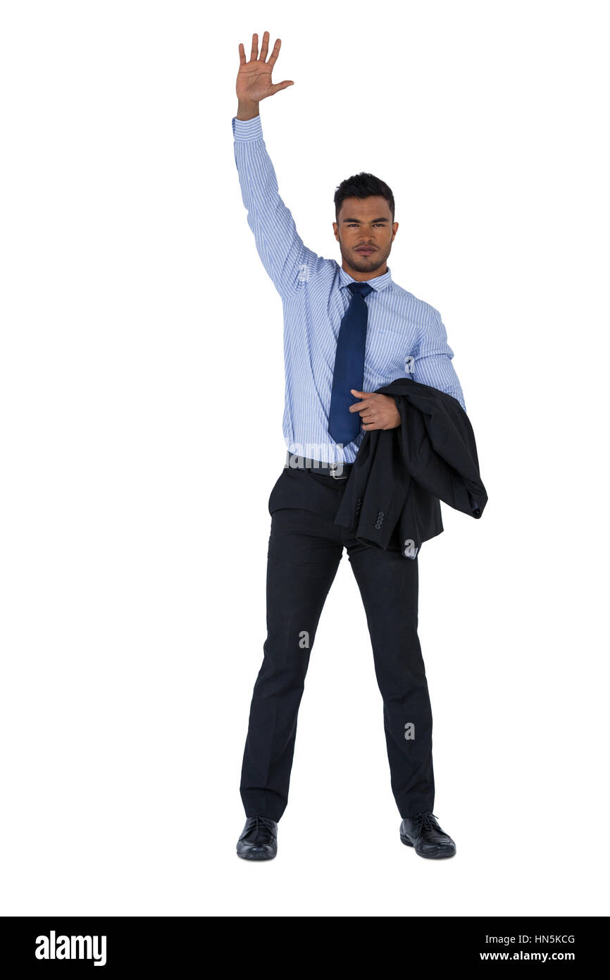 Portrait of businessman with hand raised against white background Stock ...
