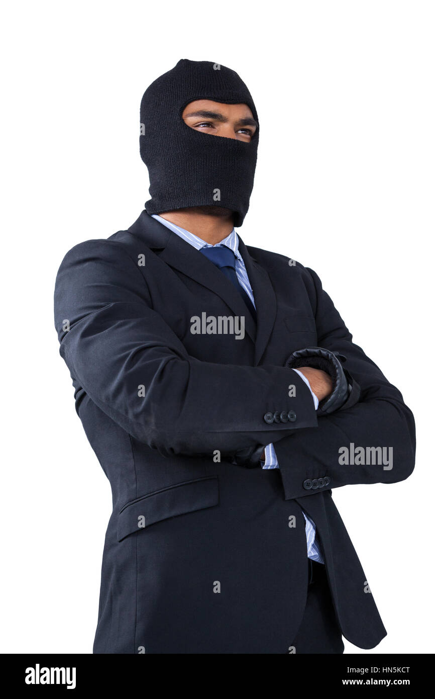 Hacker standing with arms crossed against white background Stock Photo ...