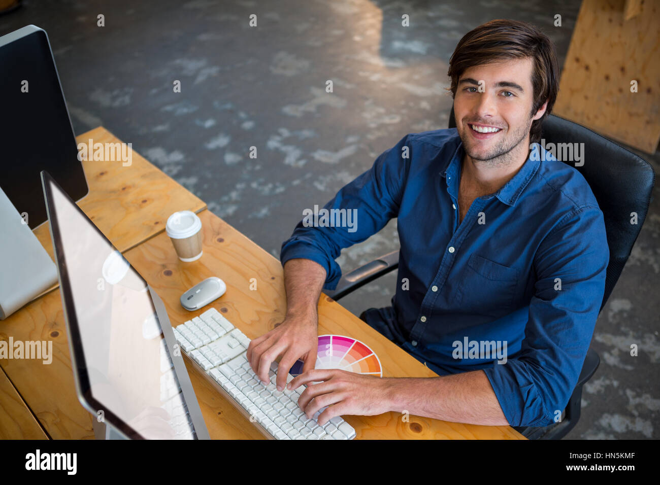 Portrait of male graphic designer at desk in office Stock Photo - Alamy