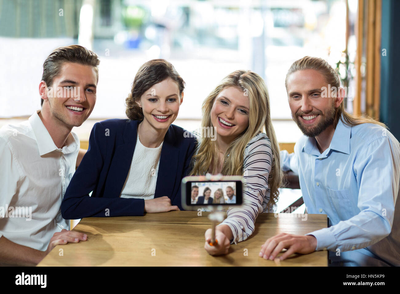 Happy friends taking selfie from mobile phone in cafÃƒÂ© Stock Photo ...