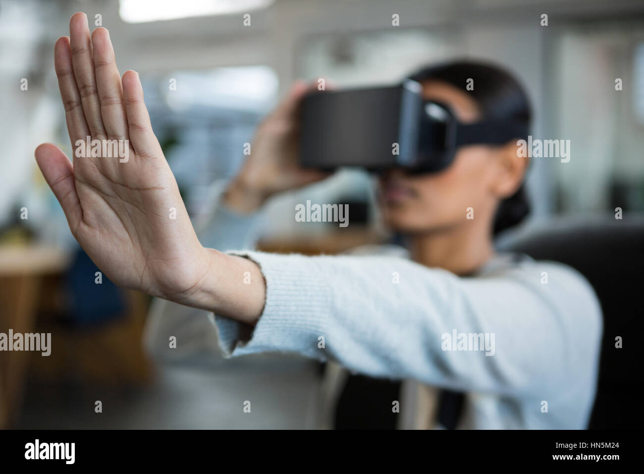 Businesswoman using virtual reality headset in office Stock Photo - Alamy