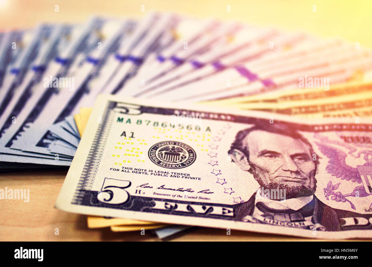 American 5 dollar bills scattered randomly with the portrait of Abraham ...
