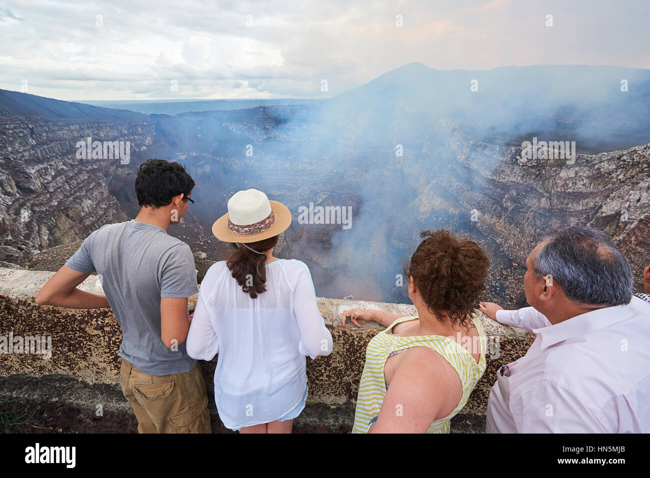 family of four people look at volcano crater during vacations Stock ...