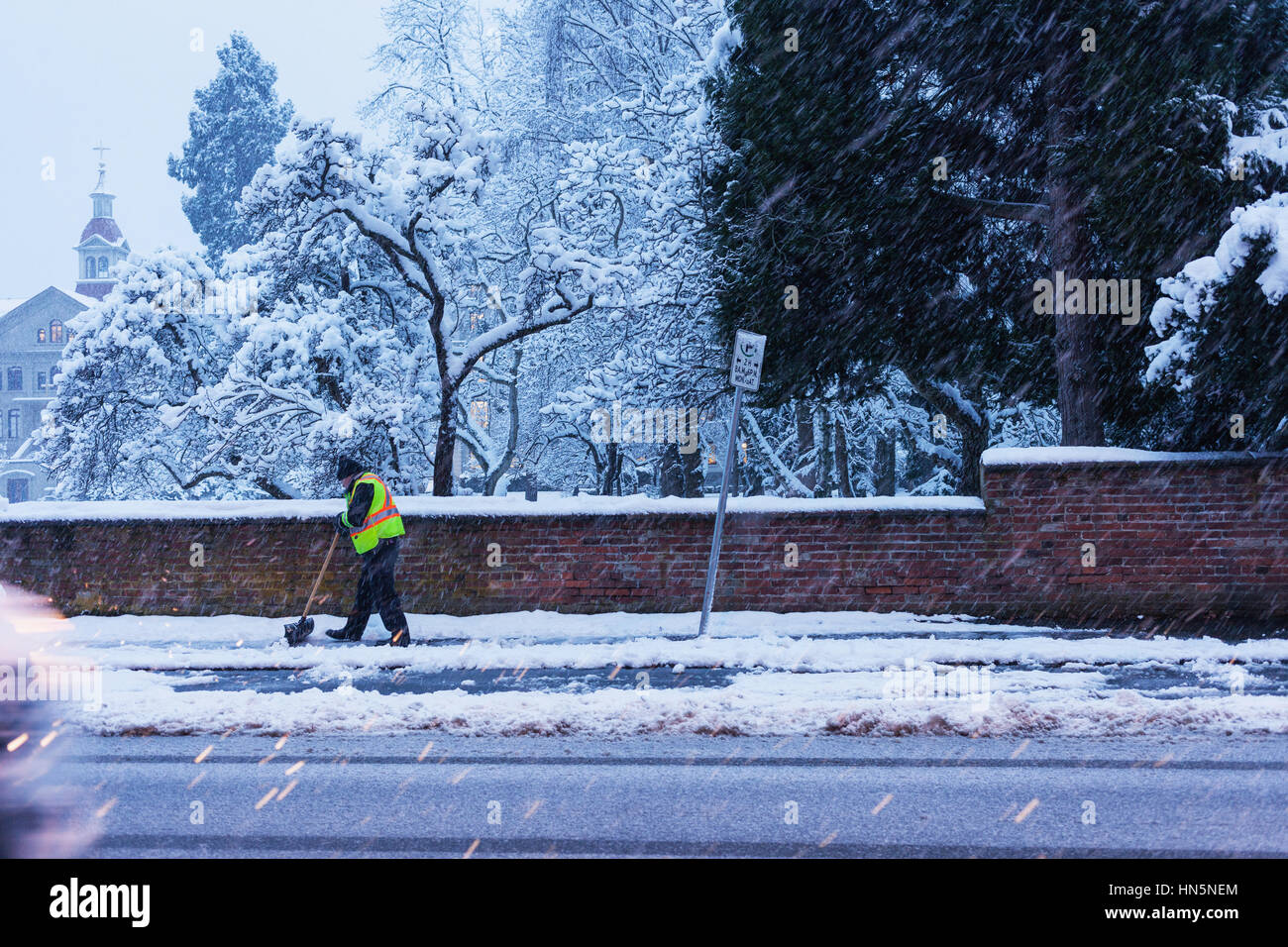 Worker scraping sidewalk of snow on Humboldt Street. Victoria, BC ...