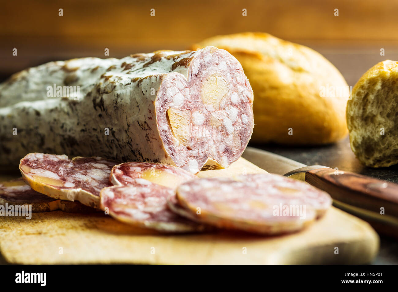 Tasty sliced salami with white mold on cutting board Stock Photo - Alamy