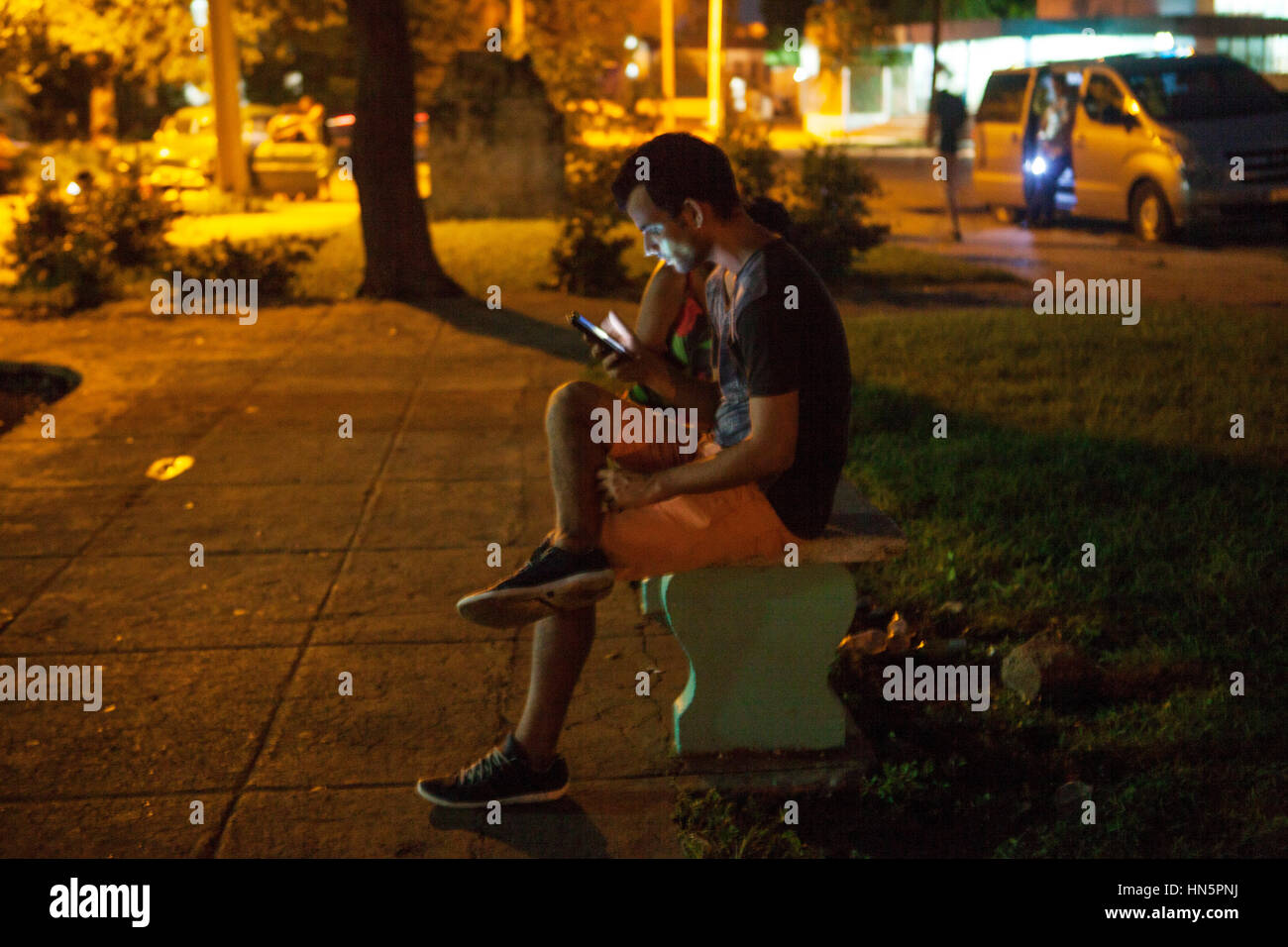 Cubans gather with their computer laptops or smart phones at night in ...