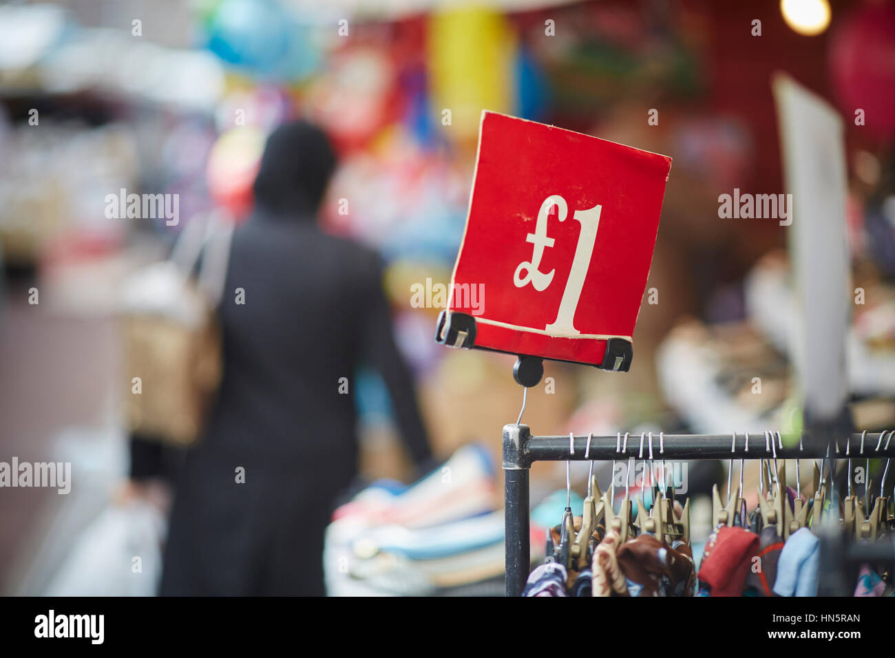Cheap clothe and £1 pound sign hanging on a market stall independent ...