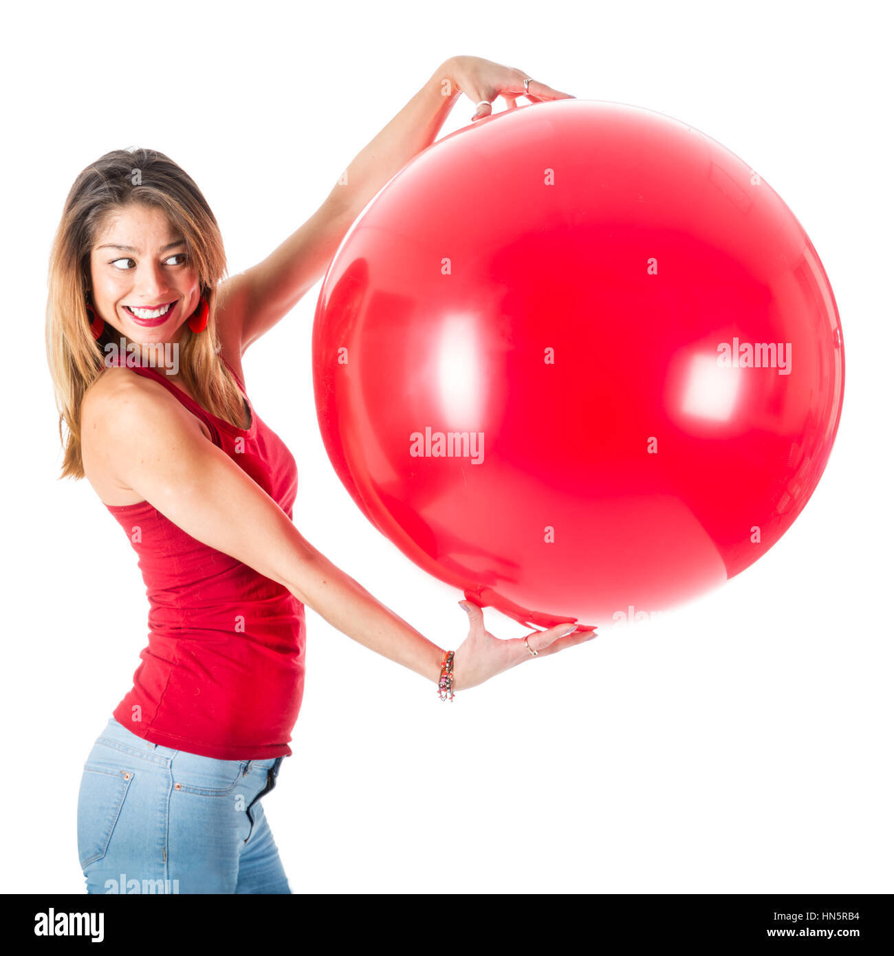 Beautiful woman with red shirt holding a mega balloon isolated on white ...