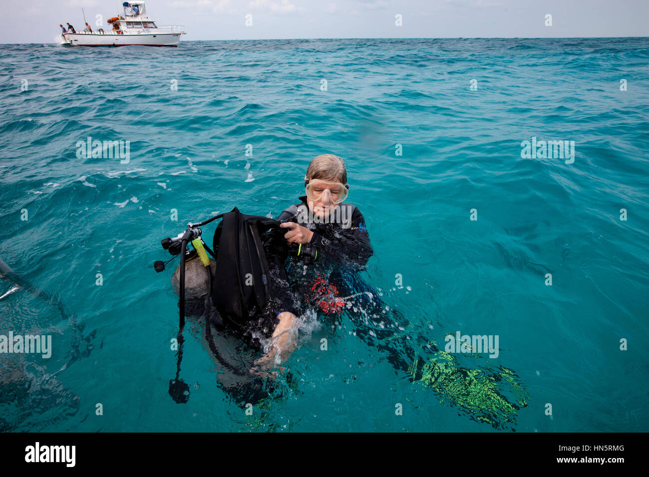 In-water gear removal by scuba diver Stock Photo - Alamy