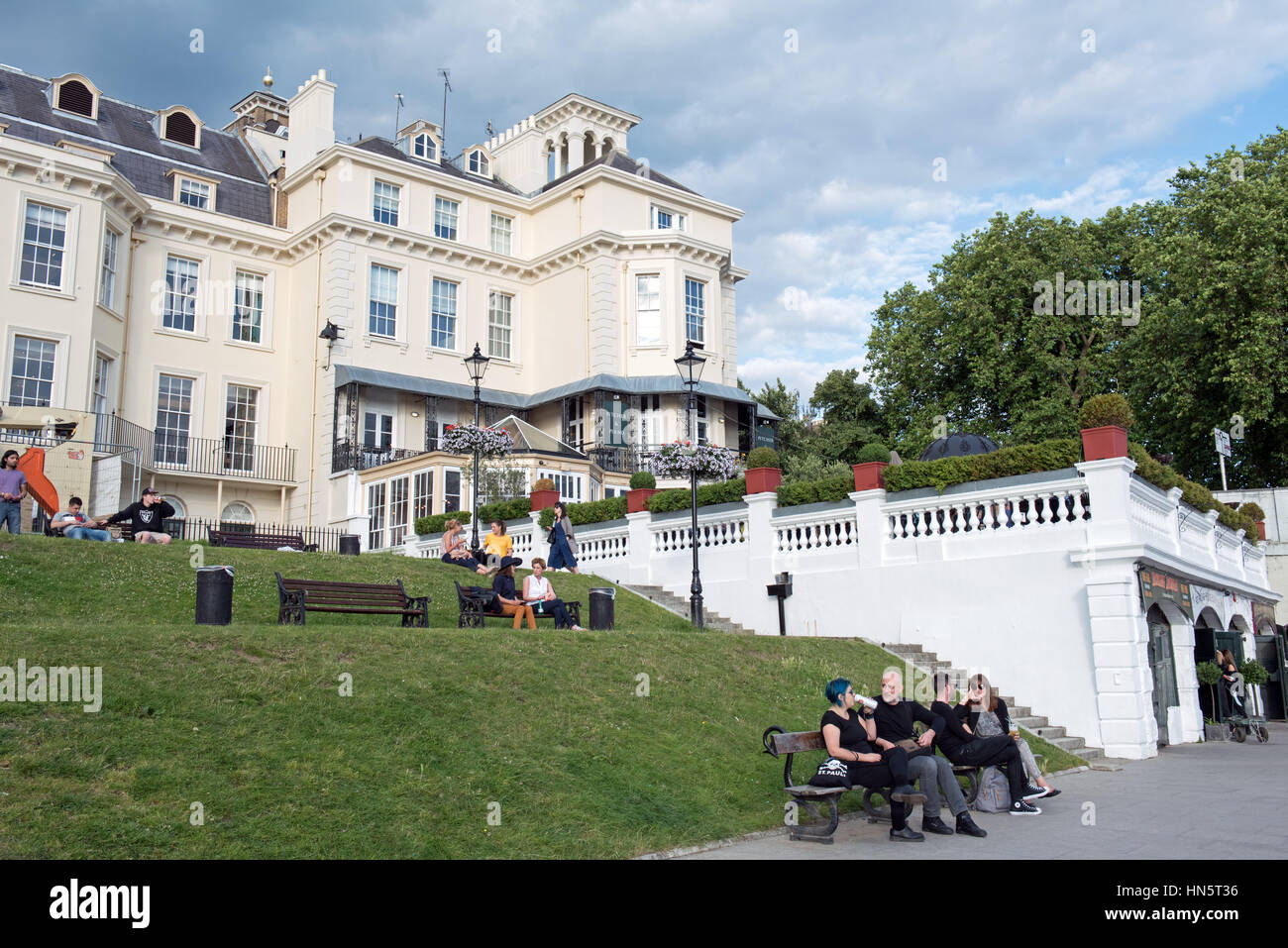 Large terraced houses above river walk, Richmond Riverside with people ...