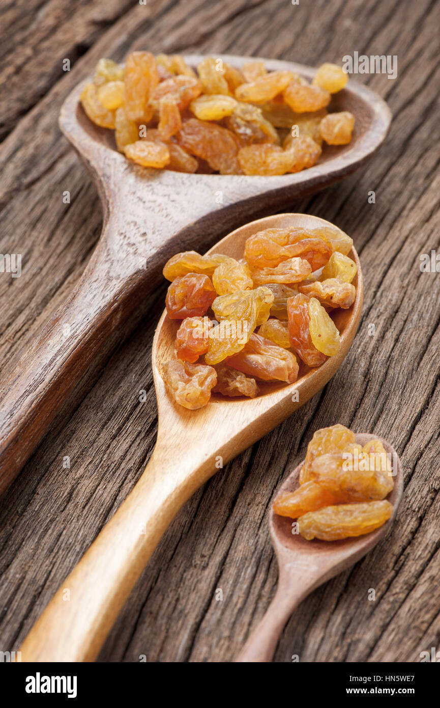 closeup heap of delicious raisins on wooden spoon Stock Photo - Alamy