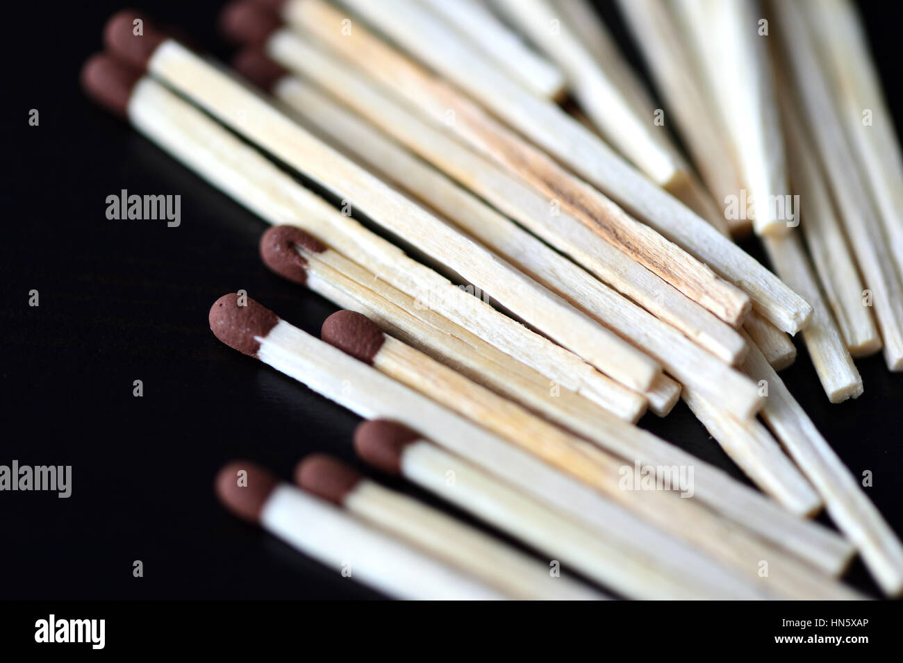Matches scattered on a dark background close up Stock Photo - Alamy