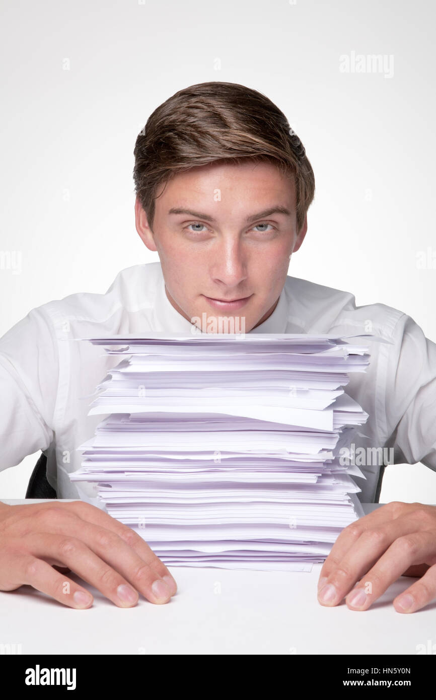 Overworked man pile of papers hi-res stock photography and images - Alamy