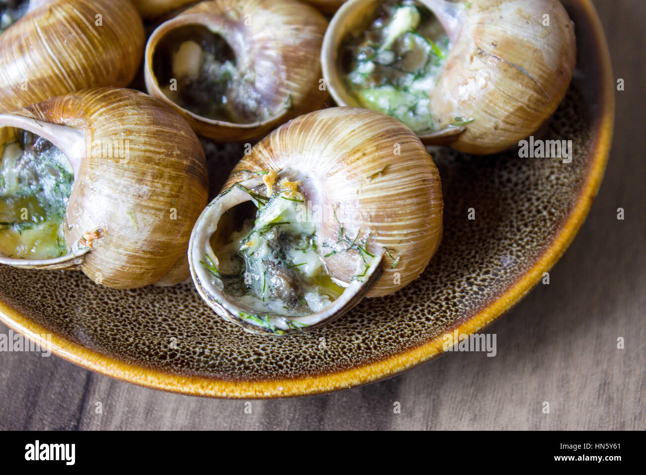 Eating the fried snails in garlic butter, background Stock Photo - Alamy