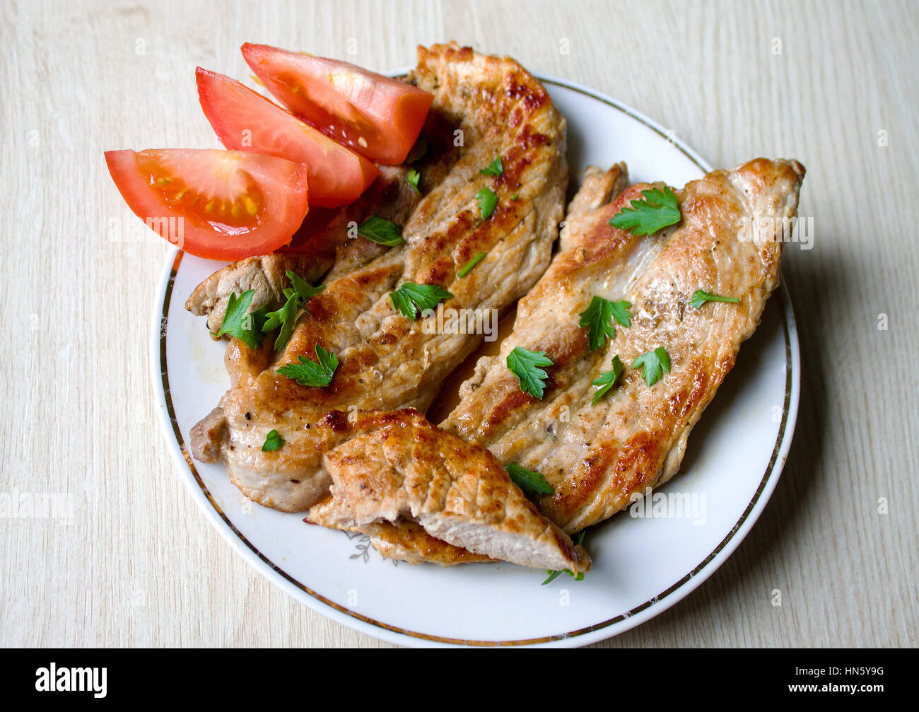 grilled pork neck with rosemary and tomatoes, the background Stock ...