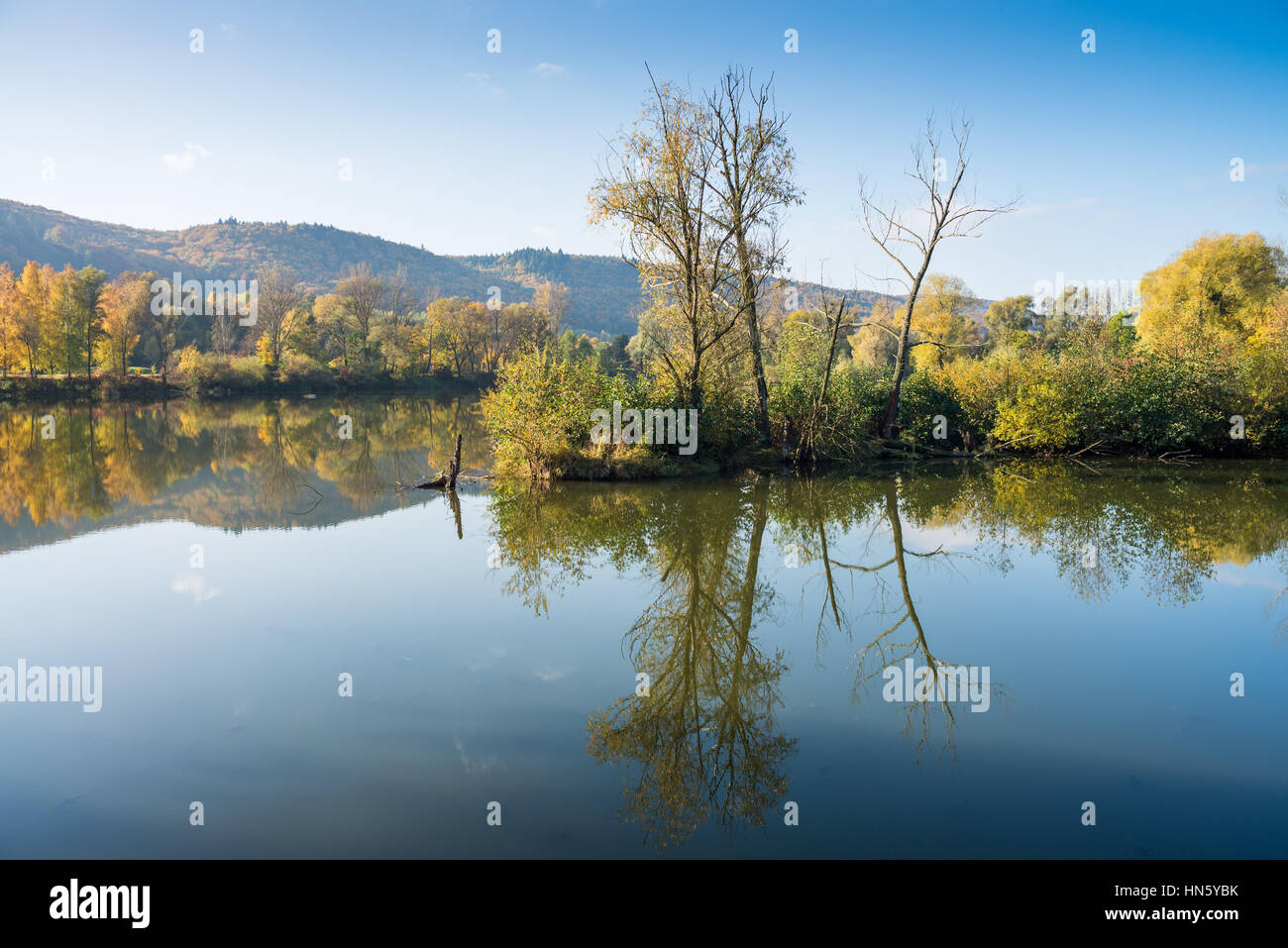 autumn landscape with colorful trees mirrored in the lake, Moravia ...