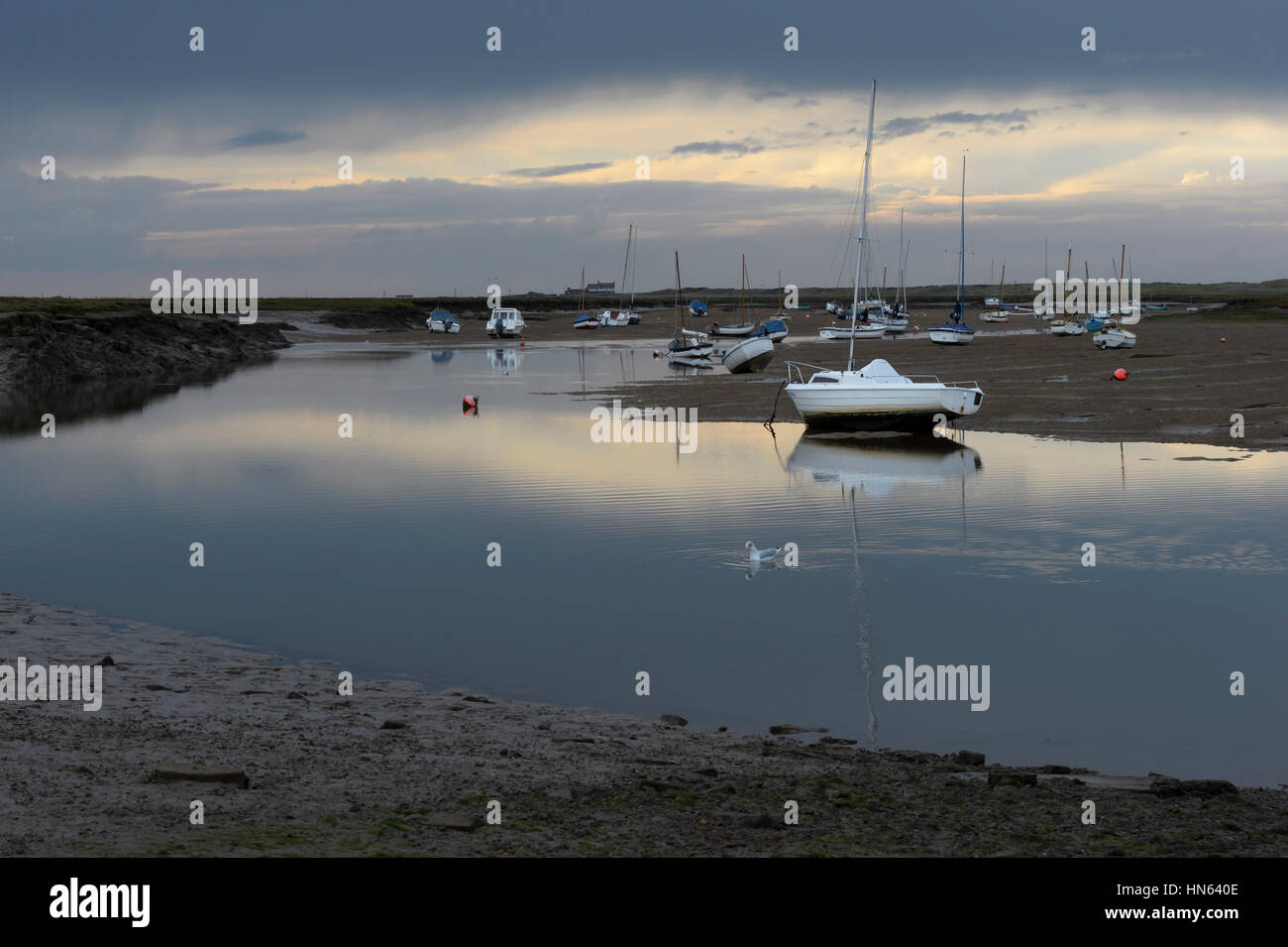 Tidal creek and yachts at Brancaster Staithe harbour, Norfolk, England ...