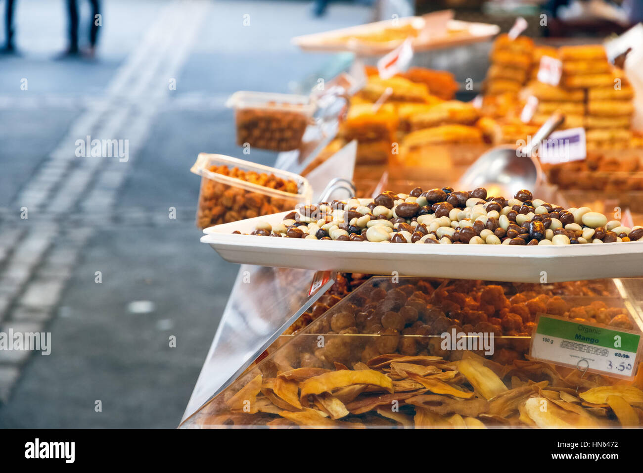 Chocolate macadamia nuts on display at a dried fruits and nuts stall in ...